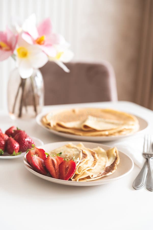 French Crepes with Chocolate Spread and Strawberries on White Table ...