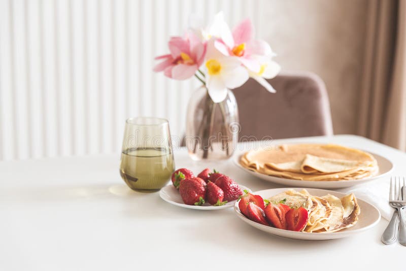 French Crepes with Chocolate Spread and Strawberries on White Table ...
