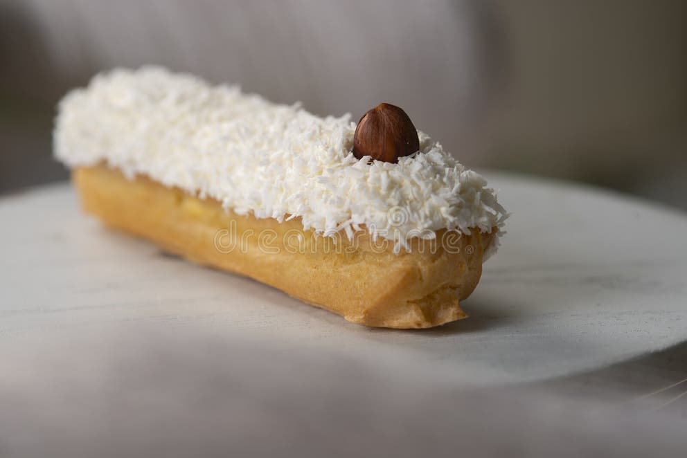 French Eclair with Coconut Crumble Hazelnut. Stock Image - Image of ...