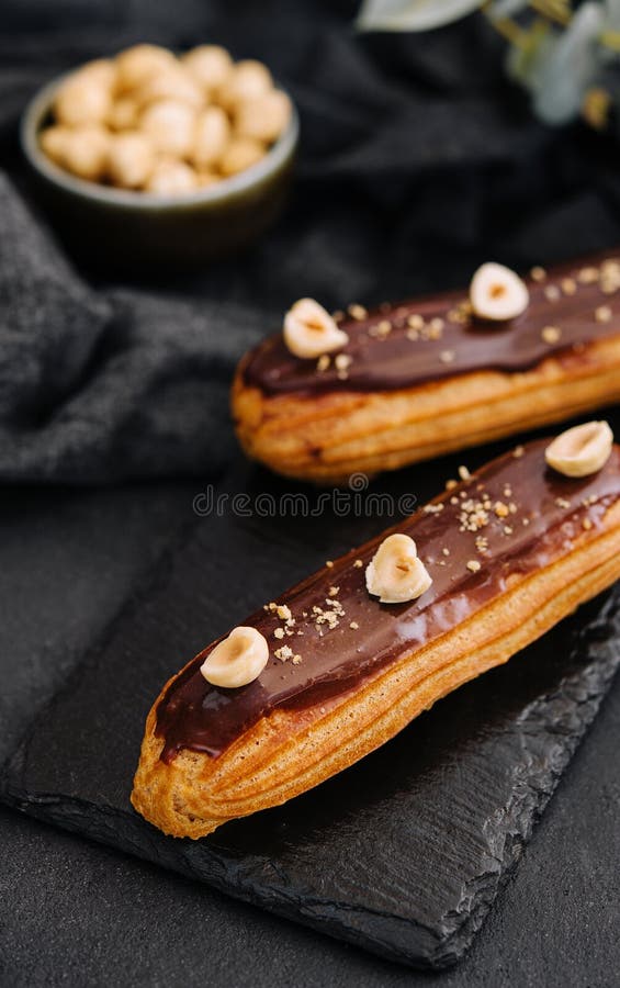 French Eclairs with Chocolate and Hazelnuts Stock Photo - Image of ...