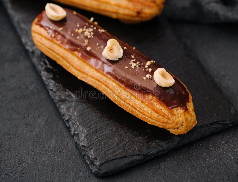 French Eclairs with Chocolate and Hazelnuts Stock Photo - Image of ...