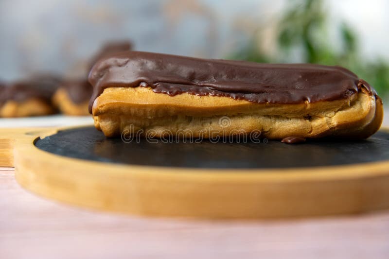 French Ecler with Chocolate. Traditional French Dessert Eclair Stock ...