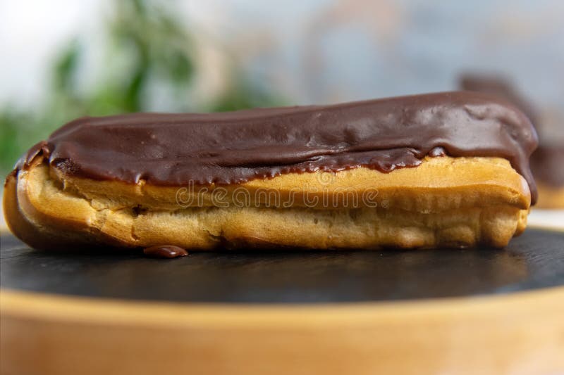 French Ecler with Chocolate. Traditional French Dessert Eclair Stock ...