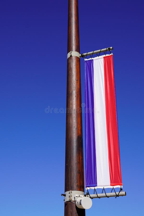 French Flag Hanging from a Pole in a Long Vertical Format in Front of a ...