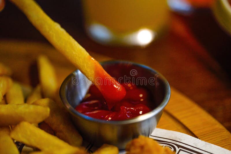 A French Fries Dipped in Ketchup Close-up Stock Image - Image of ...