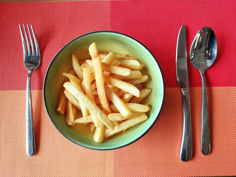French Fries in the Green Bowl with Cutteleries Stock Image - Image of ...