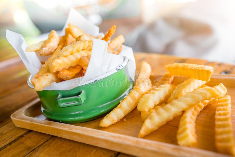 French Fries in a Green Enamel Container, on a Thai Wooden Table Stock ...