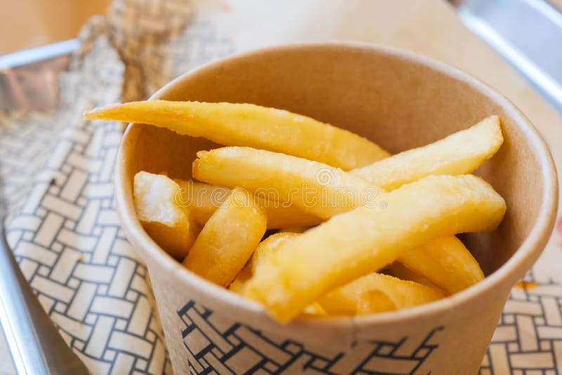 French Fries in Paper Carton on Table Stock Photo - Image of crispy ...