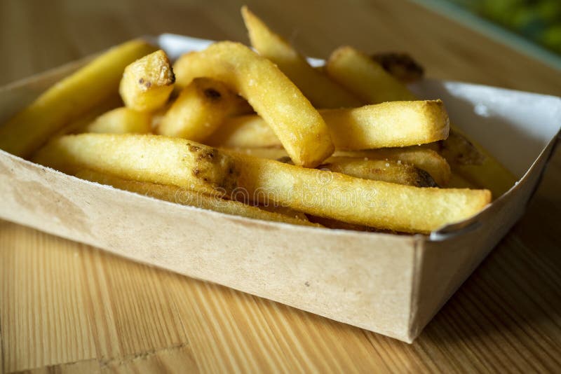 French Fries in a Paper Container on a Table Stock Image - Image of ...