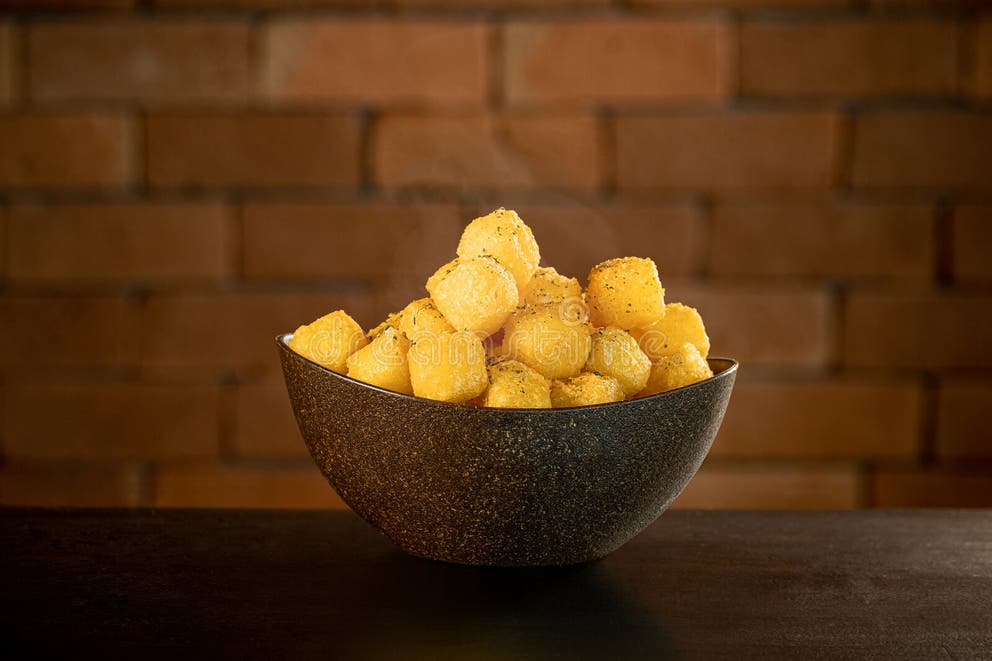 French Fries in Pot on Table in Front of Brick Wall Stock Photo - Image ...
