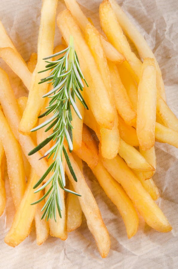 French Fries with Rosemary on Brown Paper Stock Image - Image of green ...