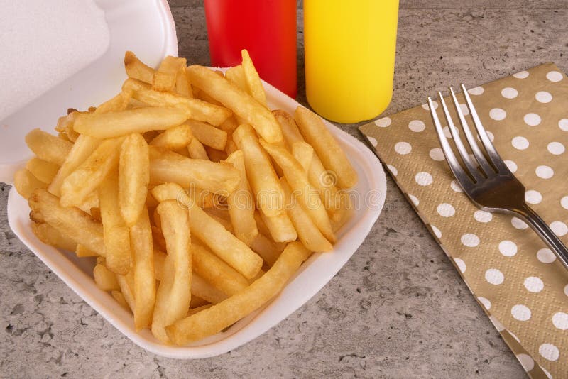 French Fries in a Take Out Container. Bottle of Ketchup and Mustard on ...