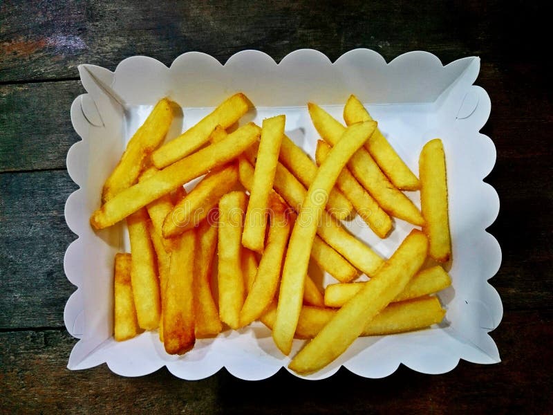 French Fries in a White Container Placed on a Wooden Table Stock Image ...