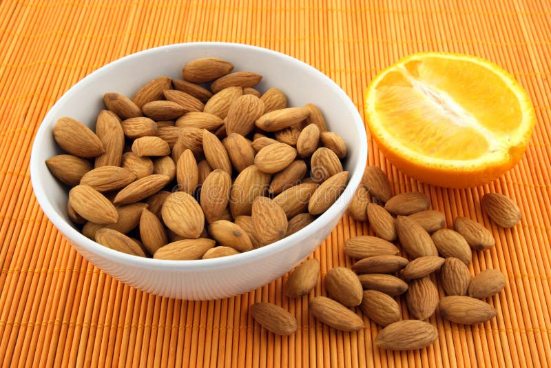Fresh almonds and orange stock photo. Image of nutrition - 4034624