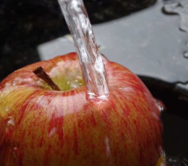 Fresh Apple during the Cleaning Process Under Running Water Stock Photo ...