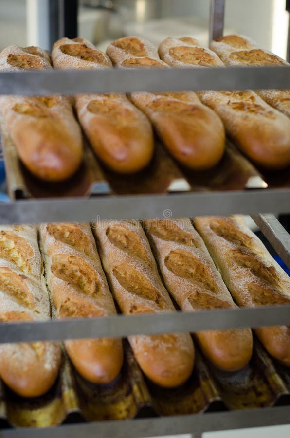 Fresh Baked Baguettes Cooling on Racks in the Bakery Stock Photo ...