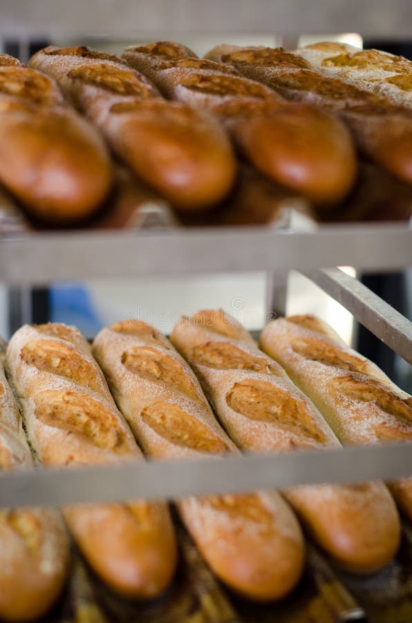 Fresh Baked Baguettes Cooling on Racks in the Bakery Stock Image ...