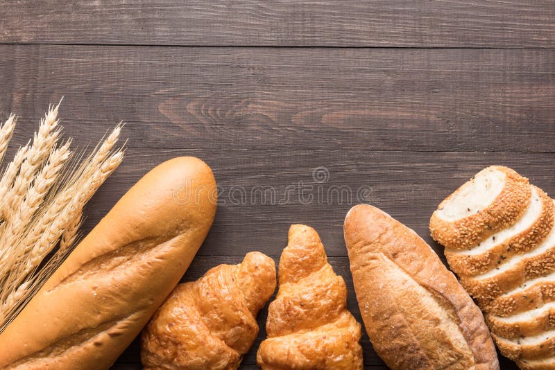 Fresh Baked Bread and Wheat on Wooden Background Stock Image - Image of ...