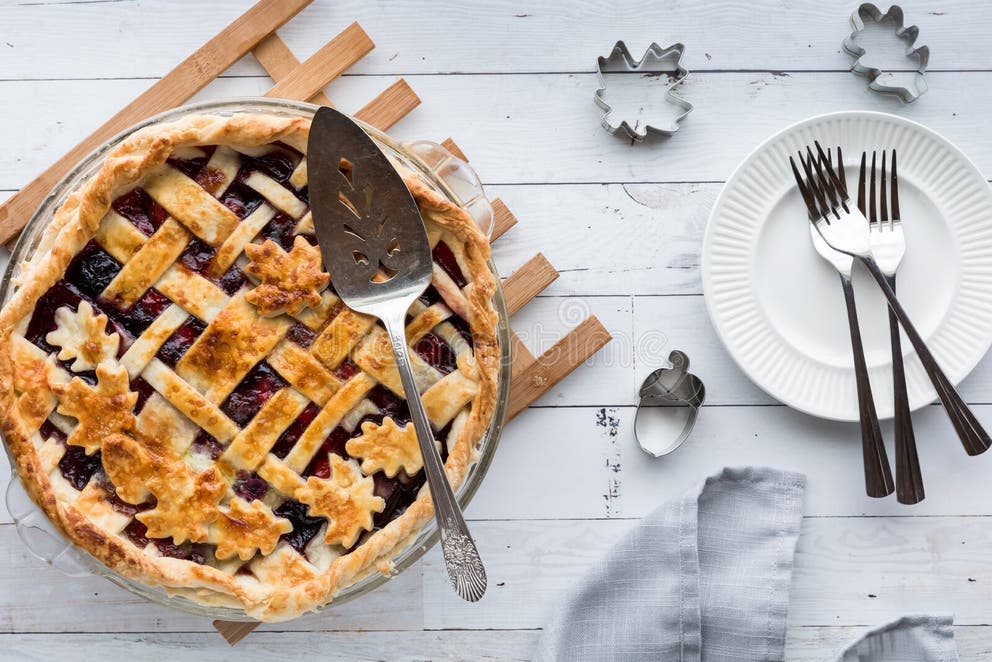 A Fresh Baked Lattice Cherry Pie with Pie Server and Plates, Ready for ...
