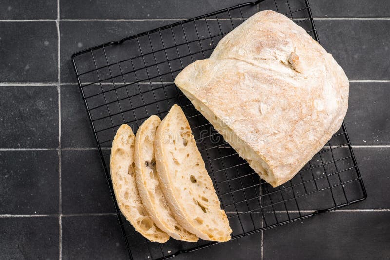 Fresh Baked and Sliced Ciabatta Bread on a Rack. Black Background Stock ...