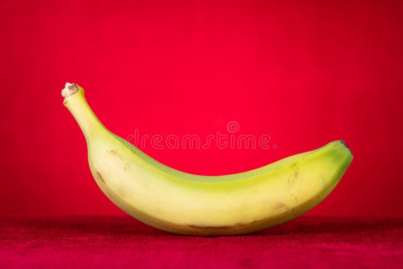A Fresh Banana on a Red Background Stock Photo - Image of horizontal ...