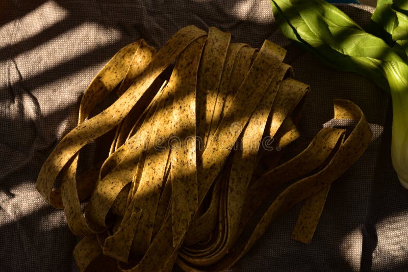 Fresh Basil Pasta Noodles in Shadow and Sunlight Pattern Stock Photo ...