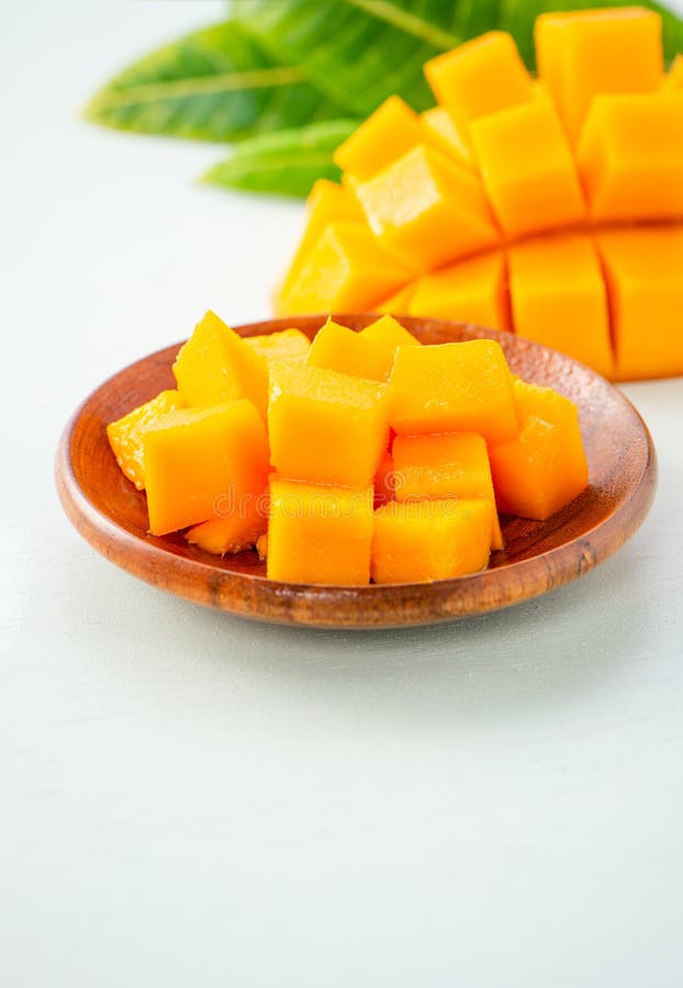 Fresh and Beautiful Mango Fruit with Sliced Diced Mango Chunks on a ... Fresh and Beautiful Mango Fruit with Sliced Diced Mango Chunks on a ...