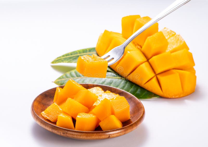 Fresh and Beautiful Mango in a Wooden Plate with Sliced Diced Mango ... Fresh and Beautiful Mango in a Wooden Plate with Sliced Diced Mango ...