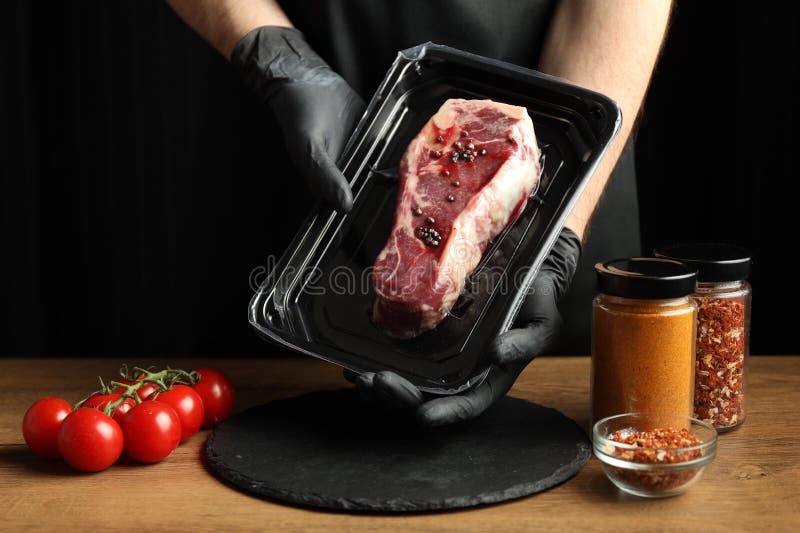 Fresh Beef Steak in Vacuum Plastic Packaging in the Hands of the Cook ...