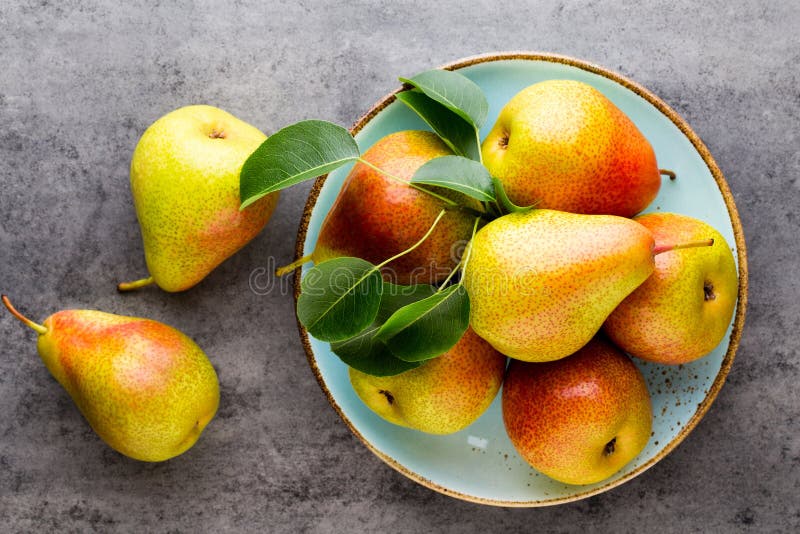 Fresh Bio Pear with Leaves on the Plate. Gray Stone Table. Stock Image ...