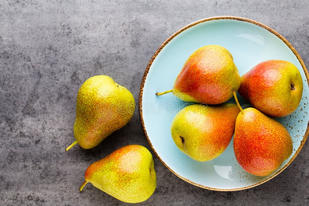 Fresh Bio Pear with Leaves on the Plate. Gray Stone Table Stock Image ...