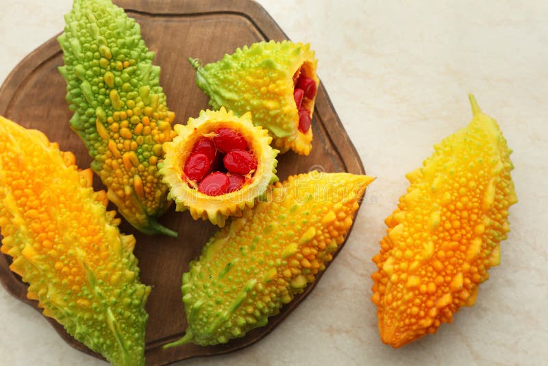 Fresh Bitter Melons with Red Seeds on Light Table, Flat Lay Stock Image ...