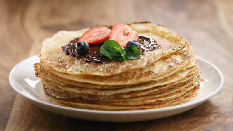 Fresh Blinis or Crepes with Melted Dark Chocolate and Berries Stock ...