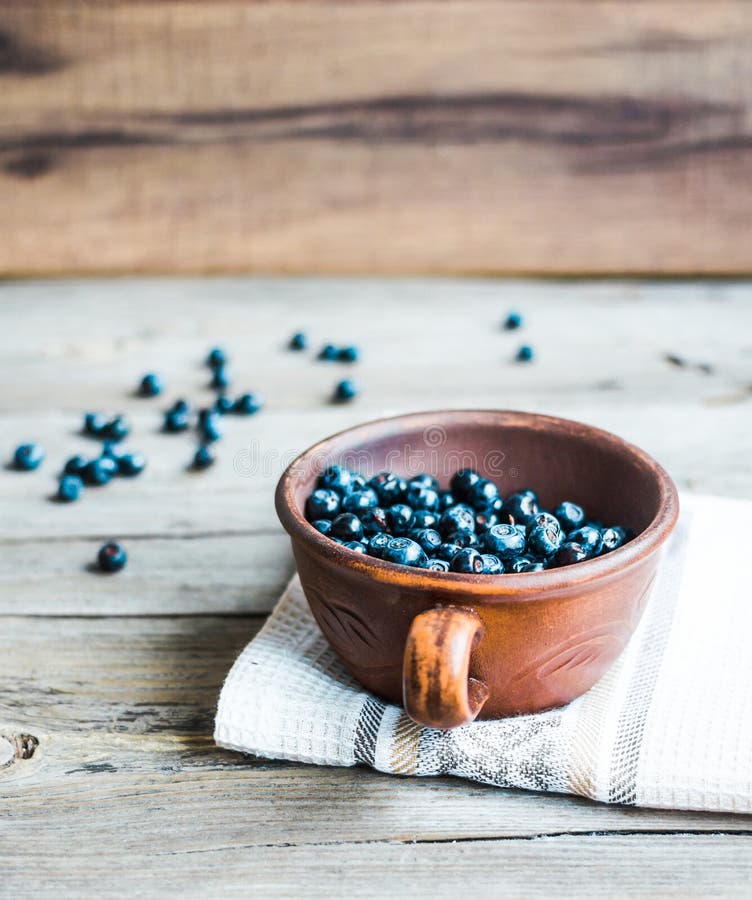 Fresh Blueberries in Pottery on Gray Wooden Background, Summer, Stock ...