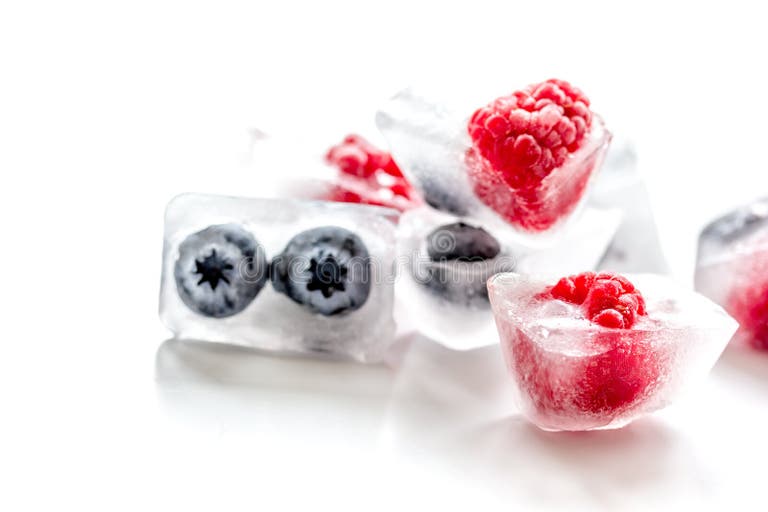 Fresh Blueberry and Raspberry in Ice on Table Background Stock Photo ...