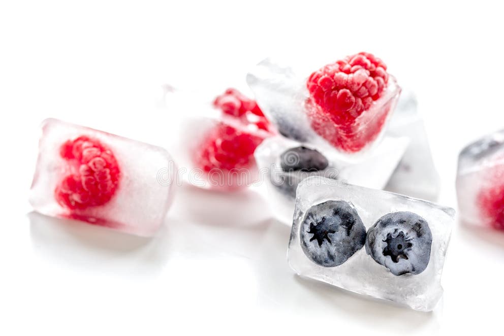 Fresh Blueberry and Raspberry in Ice on Table Background Stock Photo ...