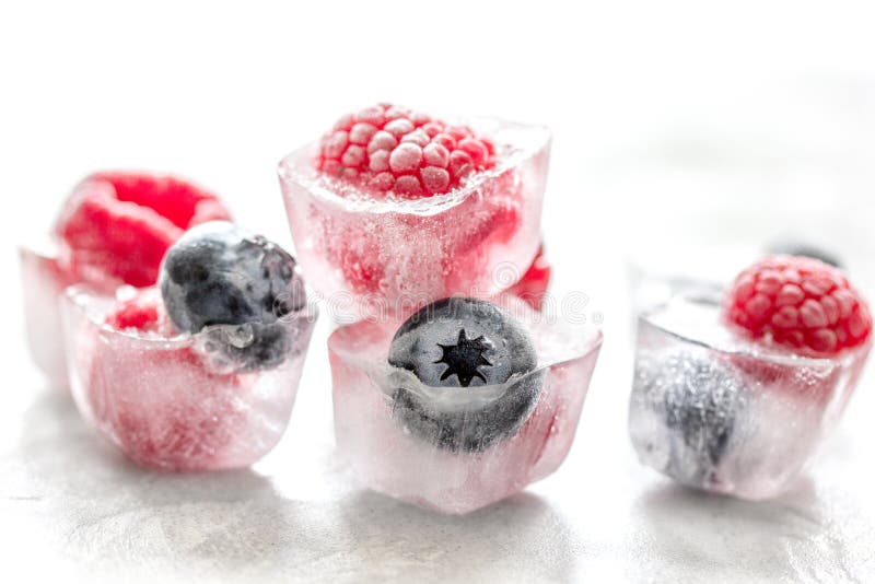 Fresh Blueberry and Raspberry in Ice on Table Background Stock Photo ...
