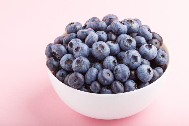 Fresh Blueberry in White Bowl on Pink Background. Side View Stock Photo ...