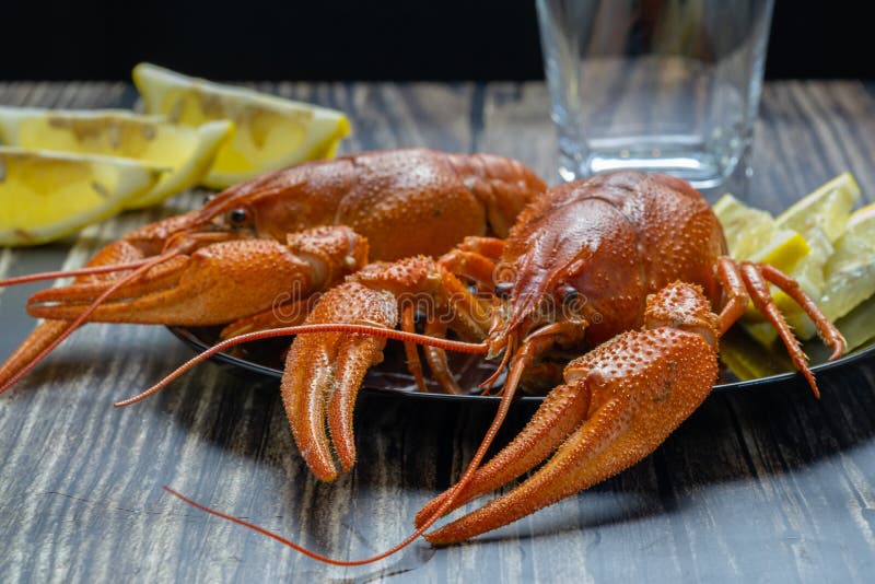 Fresh Boiled Crayfish. on a Black Plate with Yellow Lemon Stock Photo ...