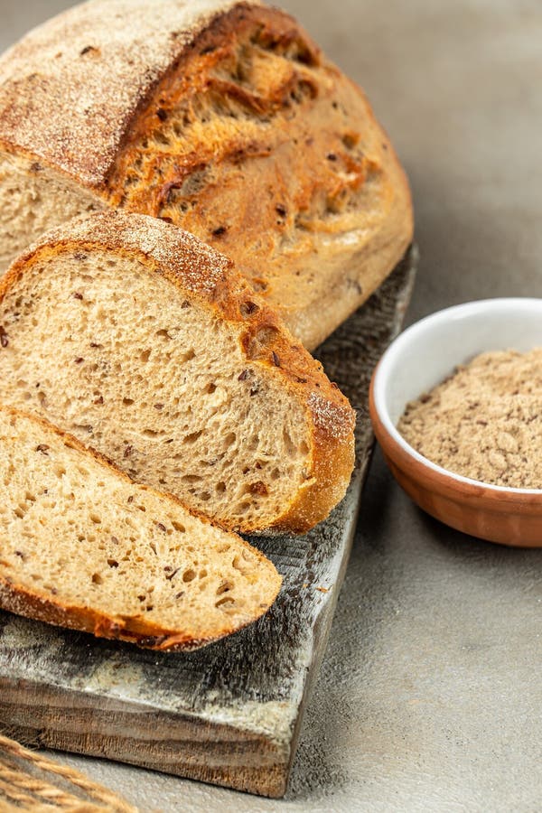 Fresh Bread with Seeds, Sesame Cut into Pieces on a Cutting Board ...