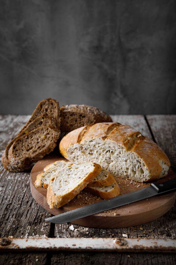 Fresh Bread Slice and Cutting Knife on Rustic Table Stock Image - Image ...