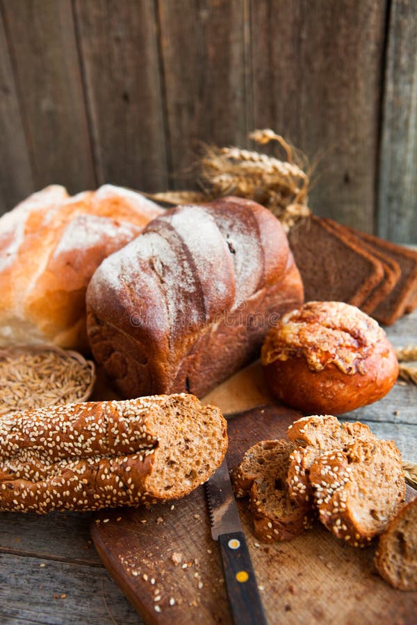 Fresh Bread Slice and Cutting Knife on Rustic Table Stock Image - Image ...