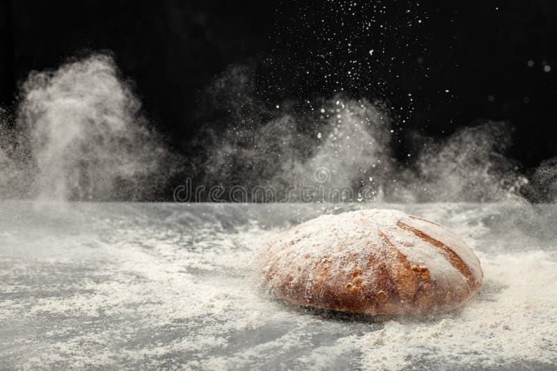Fresh Bread on Table with Powder in a Freeze Motion of a Cloud of ...