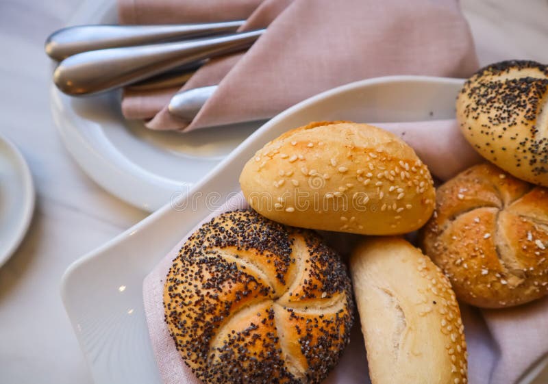 Fresh Bread on a White Plate with a Napkin. Table Setting in a ...
