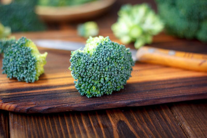 Fresh Broccoli Cutted on the Kitchen Board by Knife. Stock Photo ...