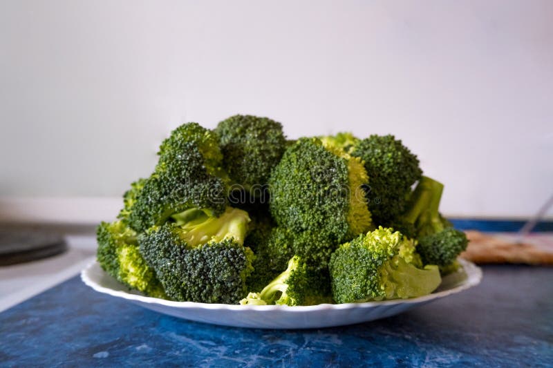 Fresh Broccoli in a Flat Plate on the Table. Preparing Broccoli for ...