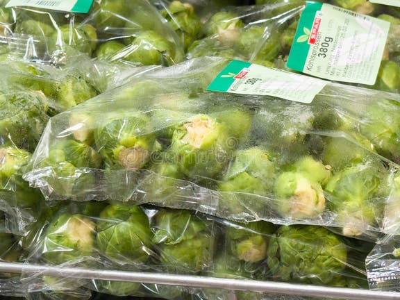 Fresh Brussels Sprouts in Plastic Packaging at Grocery Store Display ...