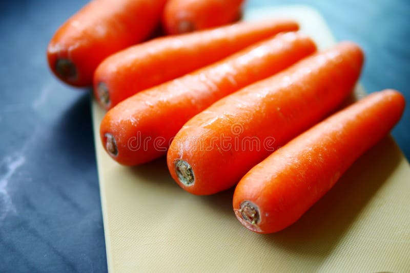 Fresh Carrots on Chopping Board on Table Stock Photo - Image of carrots ...