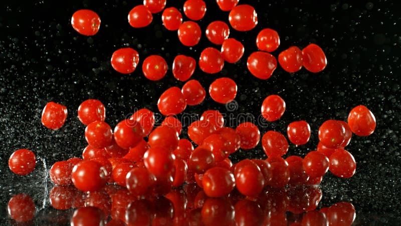 Fresh Cherry Tomatoes Falling Down on Black Background Stock Image ...