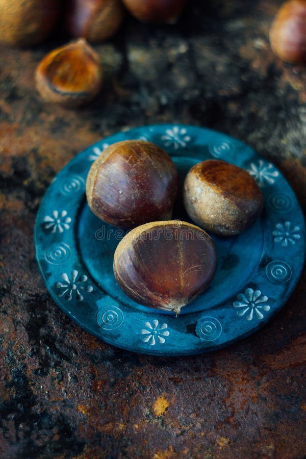 Fresh Chestnuts on Blue Plate Stock Photo - Image of snack, wooden ...